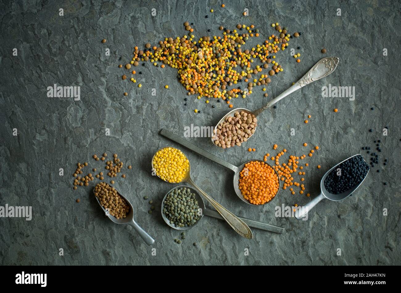 Spoons of colorful lentils Stock Photo - Alamy