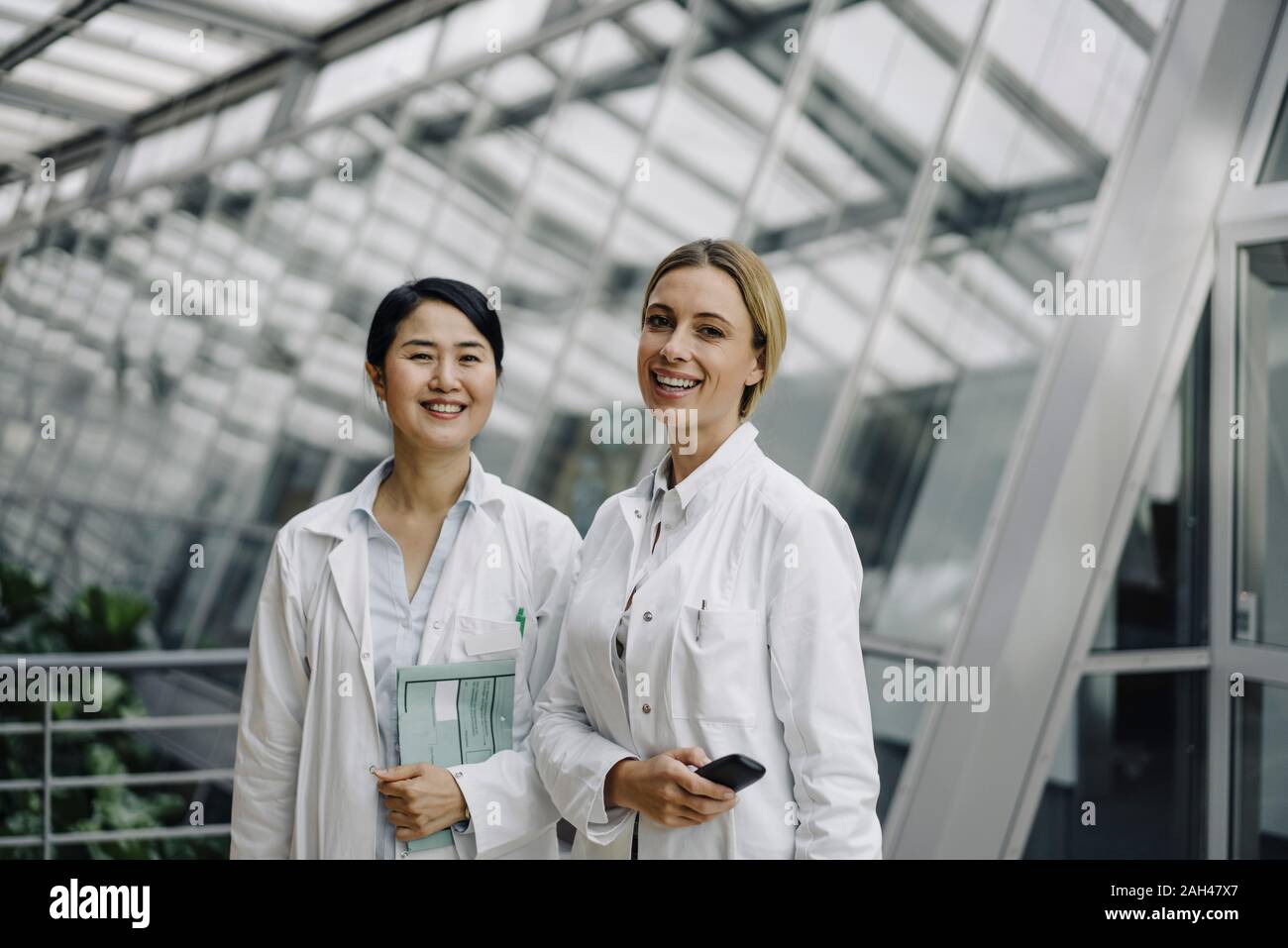 Portrait of two smiling female doctors Stock Photo - Alamy