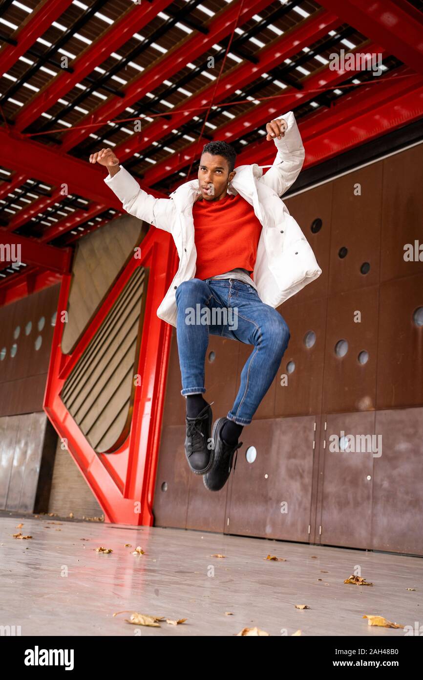 Young man jumping and dancing outdoors Stock Photo - Alamy