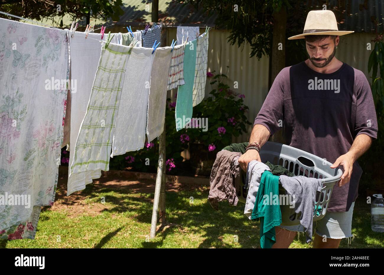 Man hanging up laundry outdoors Stock Photo - Alamy