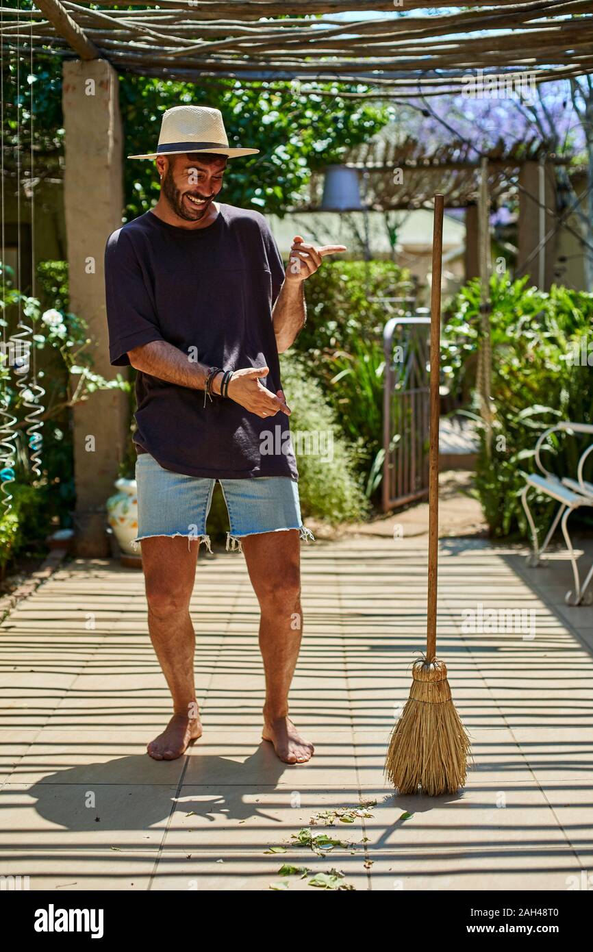 Man having fun with a broom outdoors Stock Photo - Alamy