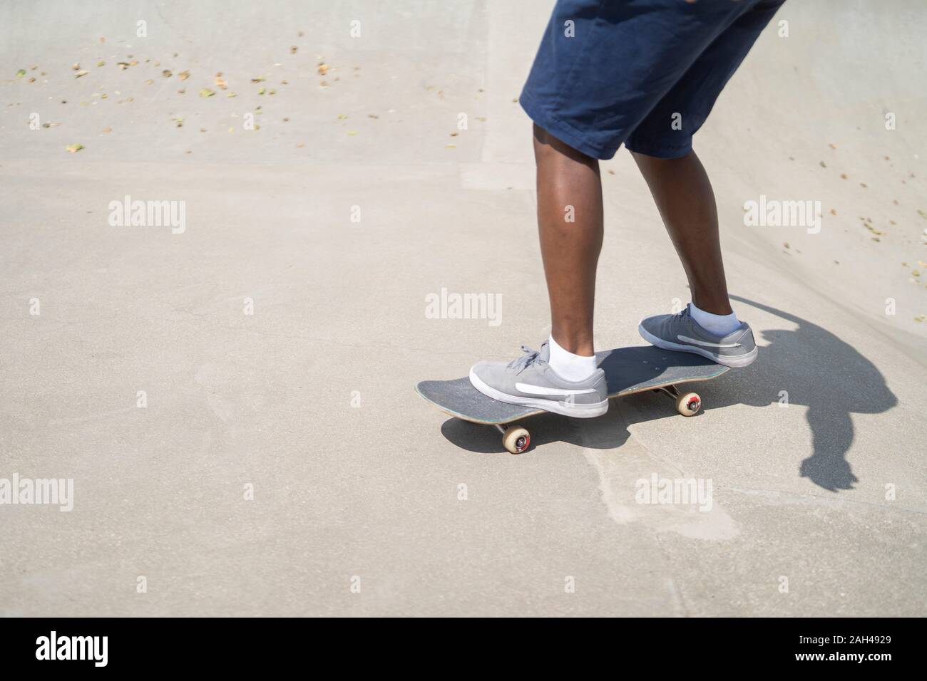 Man standing on skateboard Stock Photo - Alamy