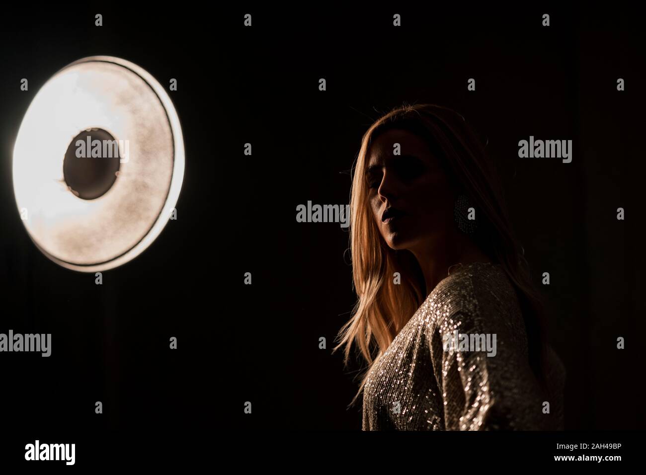 Blond woman at spotlight Stock Photo - Alamy