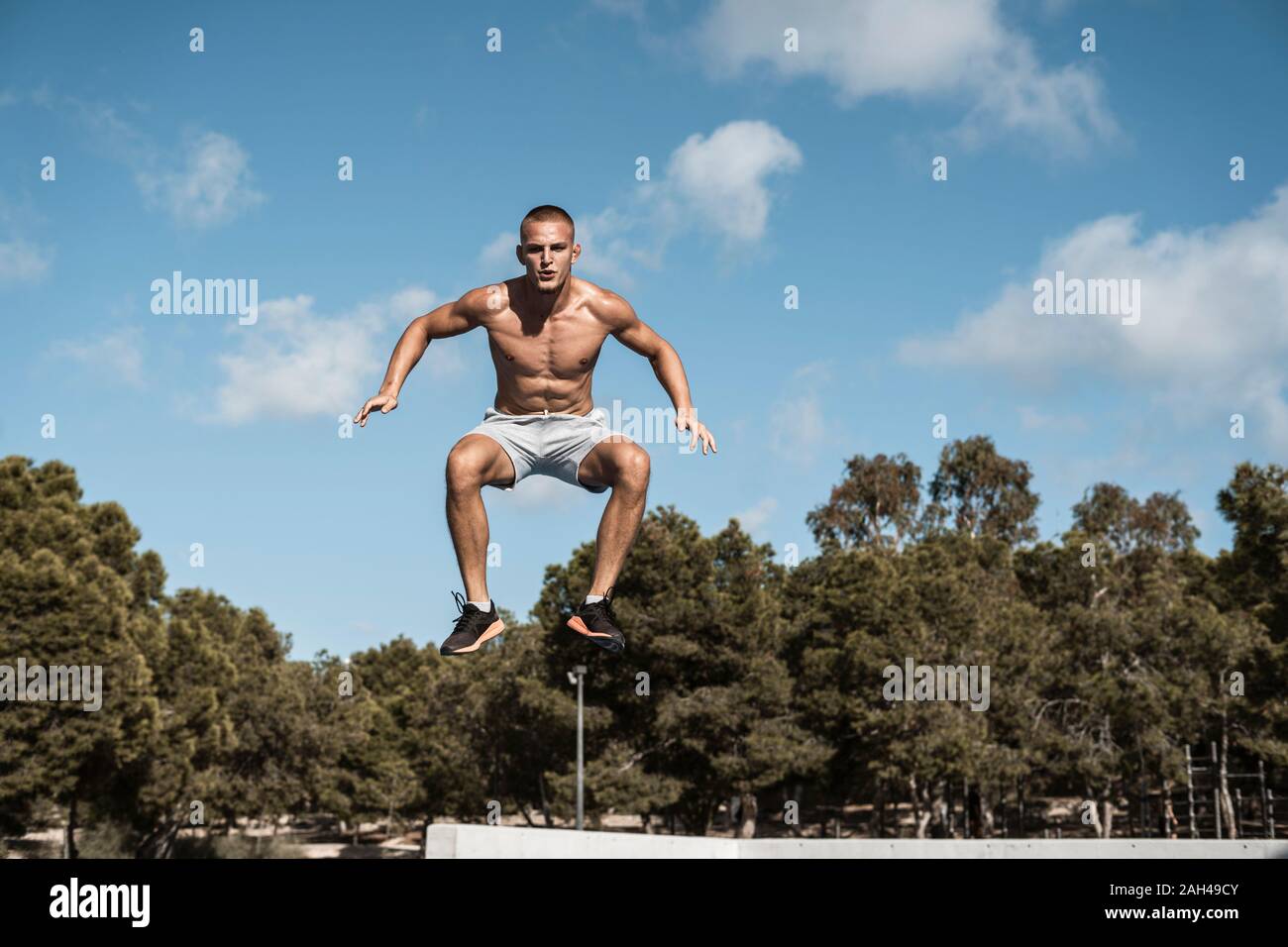 Portrait of barechested muscular man jumping outdoors Stock Photo - Alamy