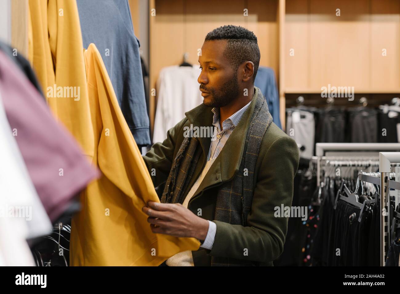 Stylish man shopping in a clothes store Stock Photo - Alamy