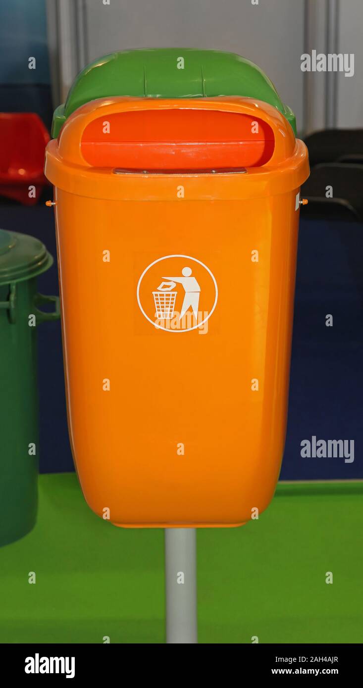 New orange plastic litter bin Stock Photo - Alamy