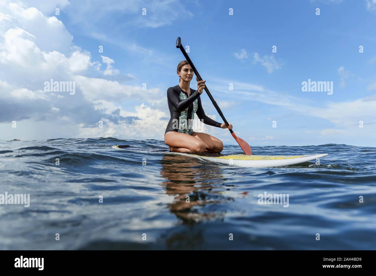 Female SUP surfer, Bali, Indonesia Stock Photo - Alamy