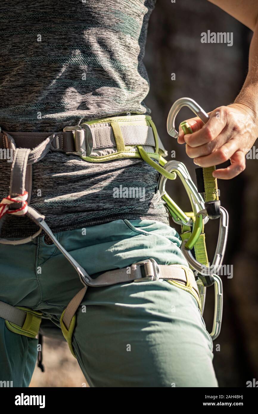 Woman putting climbing harness hi-res stock photography and images - Alamy