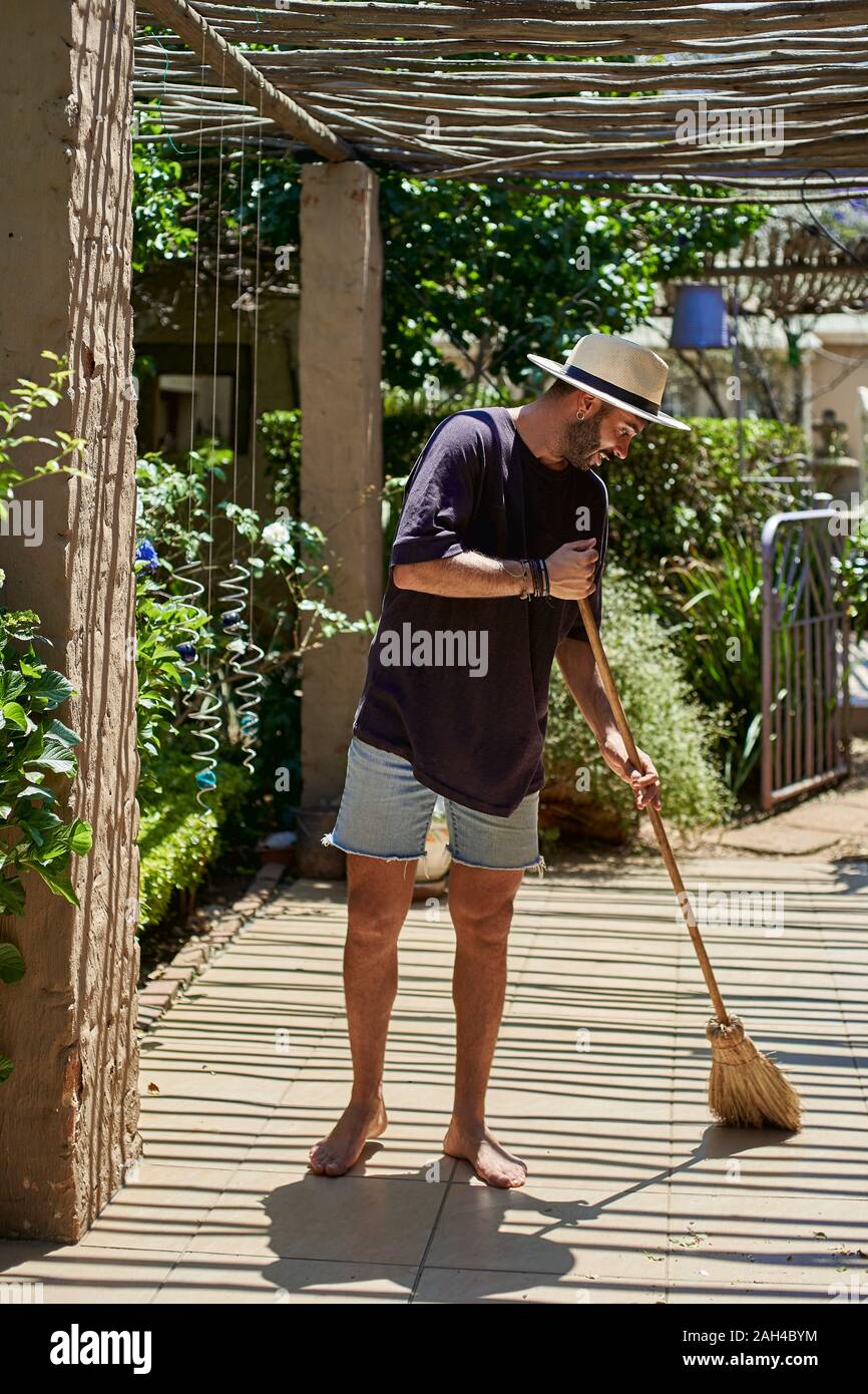 Man sweeping a terrace Stock Photo - Alamy