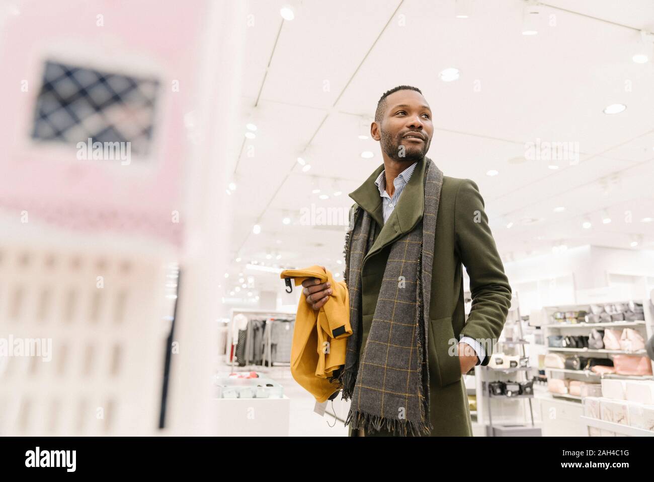 Stylish man shopping in a clothes store Stock Photo - Alamy