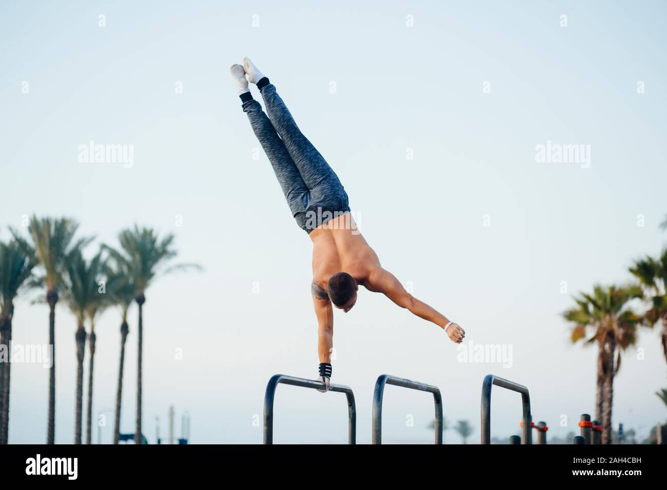 Young man practicing calisthenics at an outdoor gym Stock Photo - Alamy
