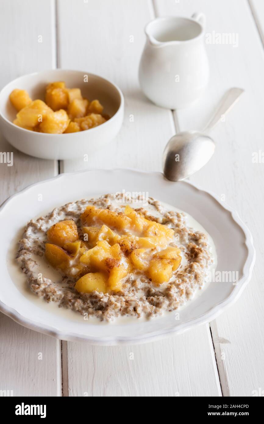 Plate of rye porridge with quince compote Stock Photo - Alamy