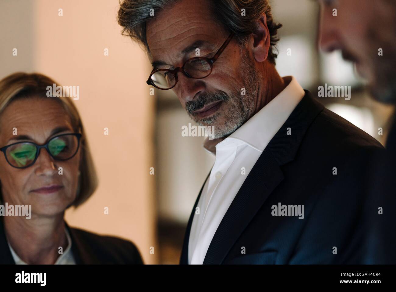 Portraitof business people in office looking down Stock Photo - Alamy