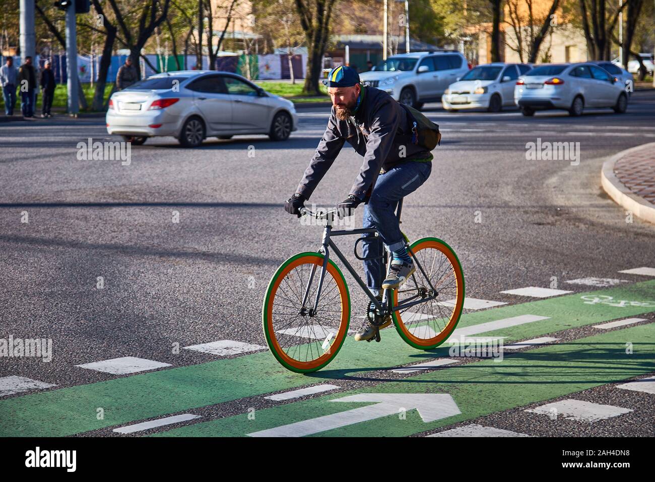 Guy is cycling around the city. Intersection on a cycle path. Eco ...