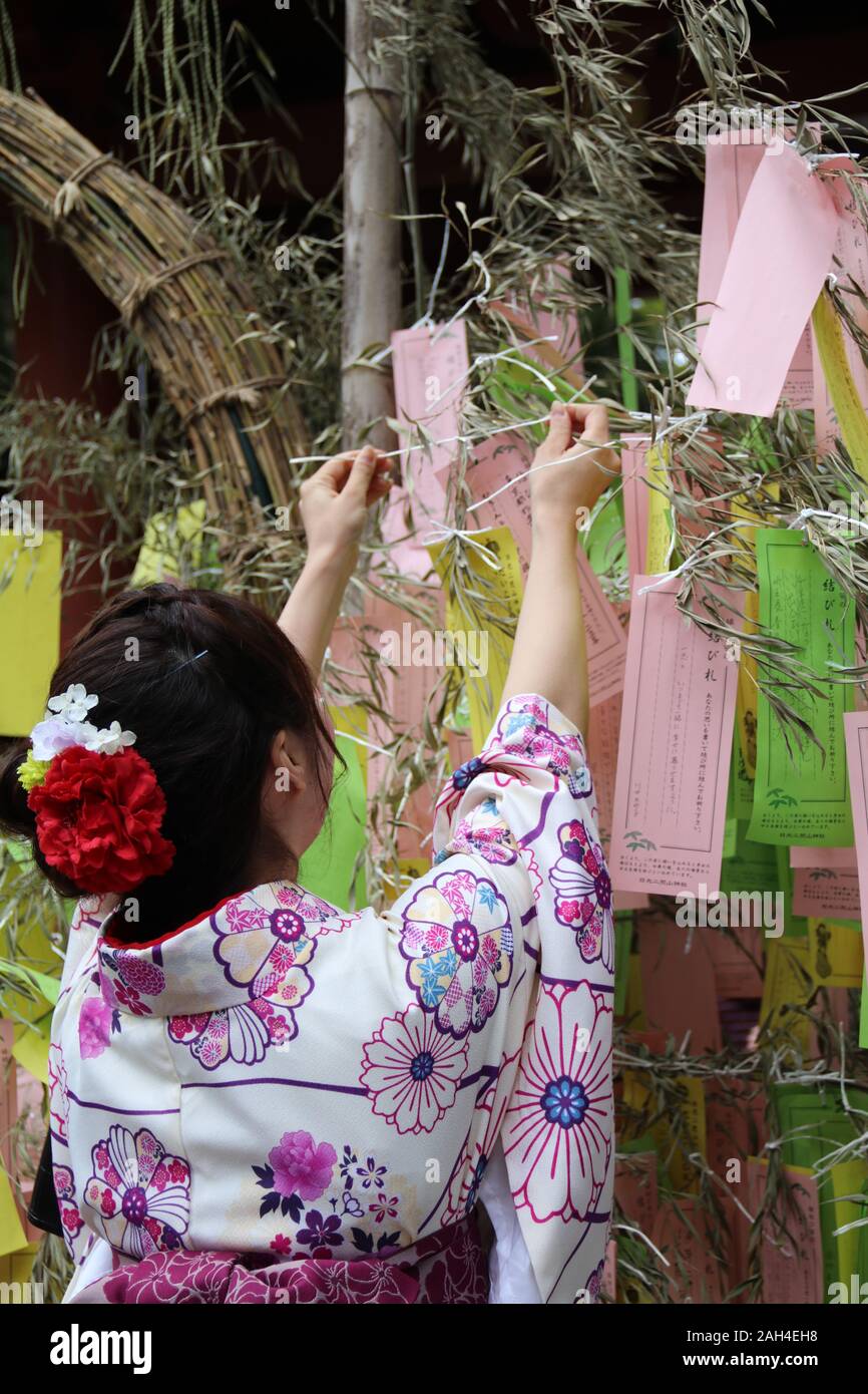 Japanese woman makes a wish at the shrine Stock Photo - Alamy