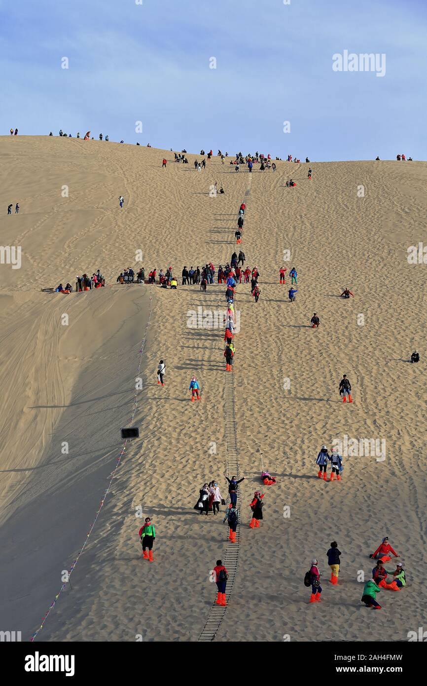 Sled-riders on the dunes around Crescent lake-Yueyaquan oasis. Dunhuang ...