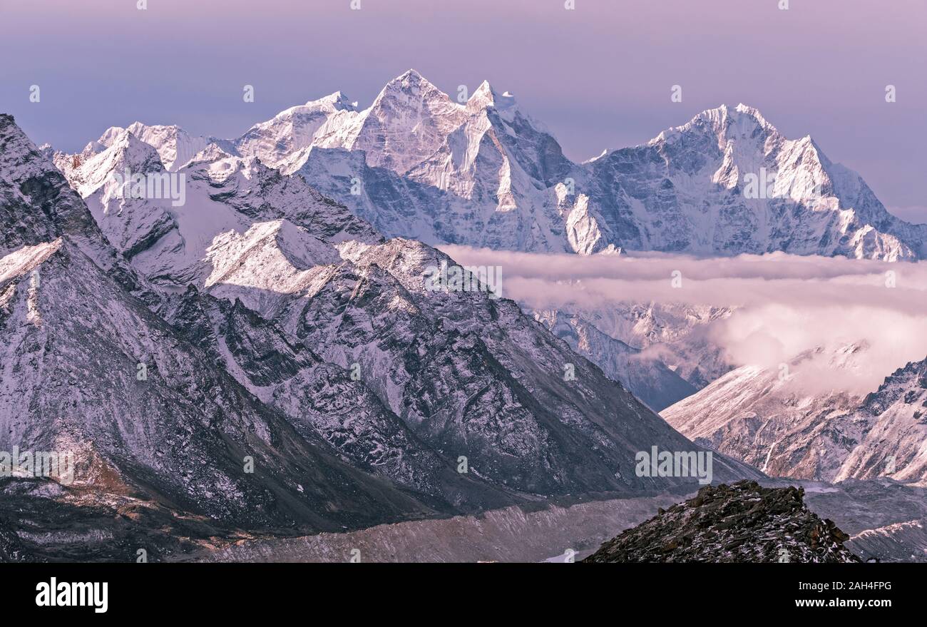 Majestic Himalayan peaks towering above the clouds at sunrise in Nepal ...