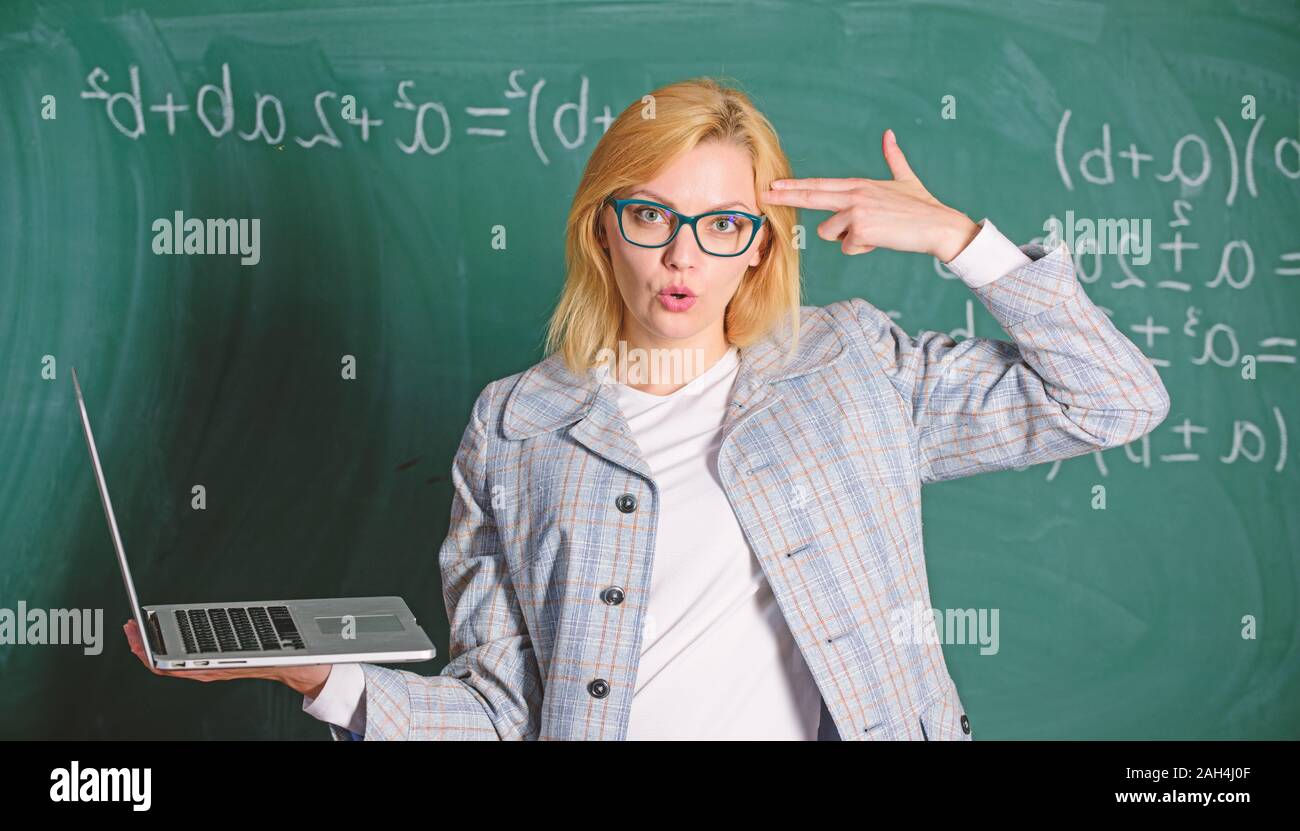 Educator smart clever lady with modern laptop hold gun gesture at her ...