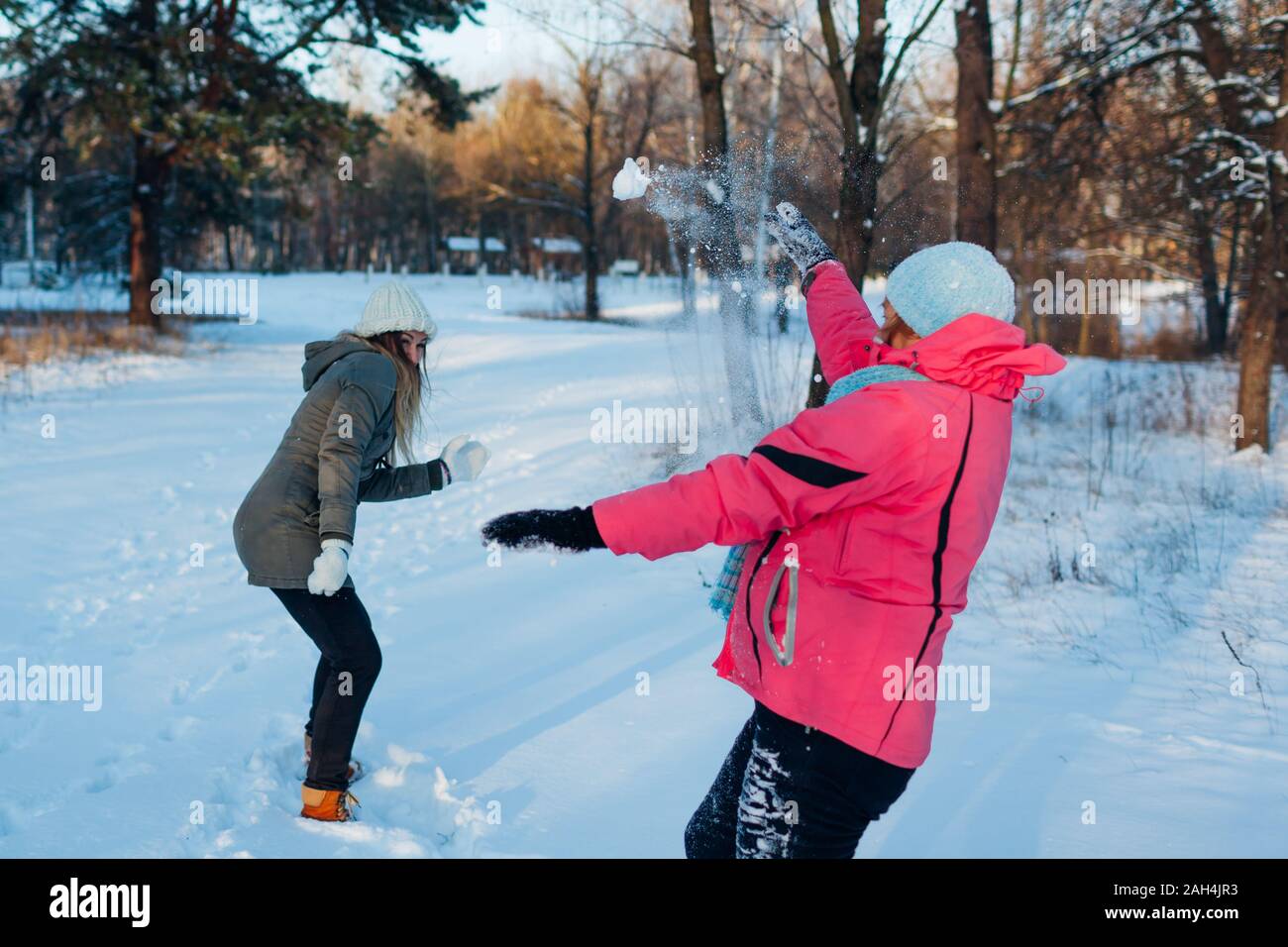 Snowballs playing in winter forest. Family mother and daughter having ...