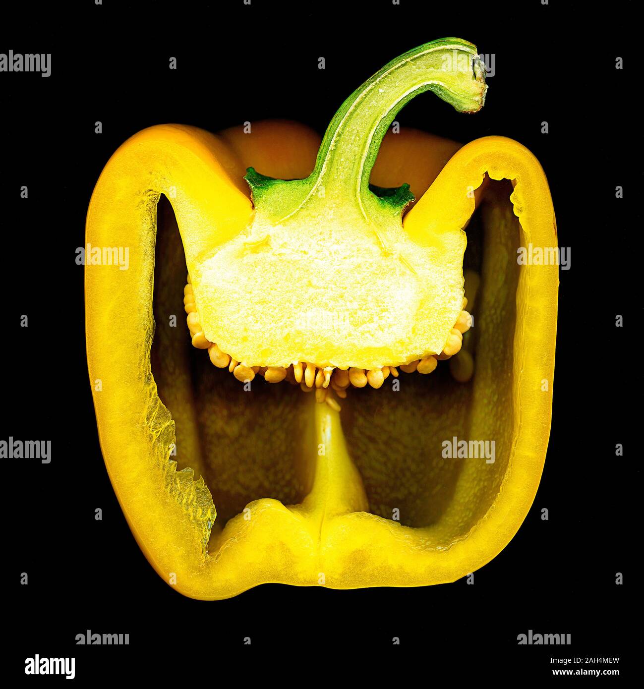 Sliced Half of Yellow Pepper on Black Background Stock Photo - Alamy
