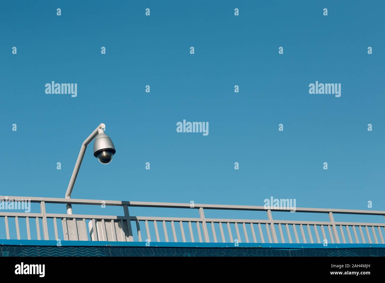 Surveillance camera on blue sky background Stock Photo - Alamy