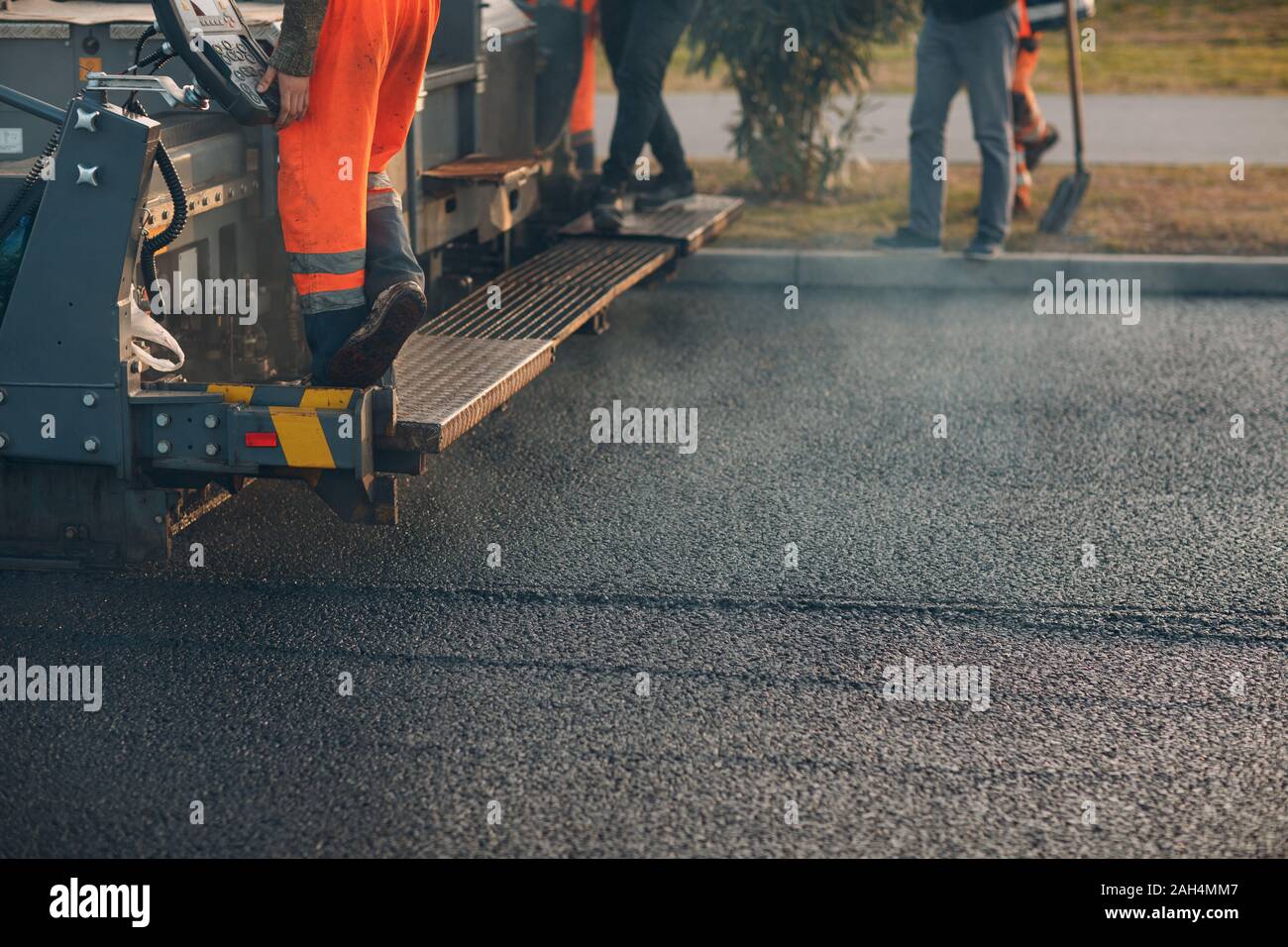Asphalt paving. Paver machine and road roller. New road construction ...