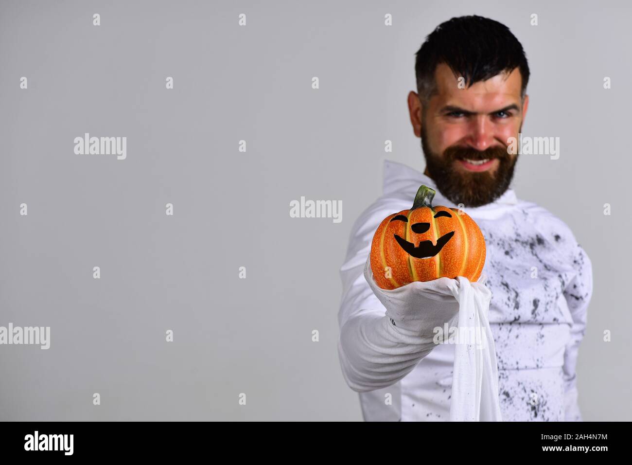 Halloween character in ghost costume. Man with evil smile on face ...
