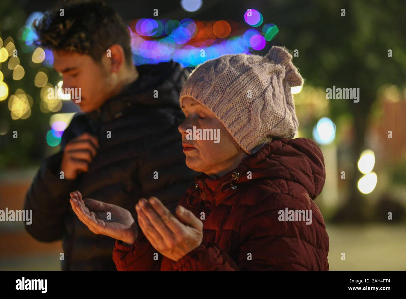 A woman praying during the Christmas Eve mass at the Catholic ...