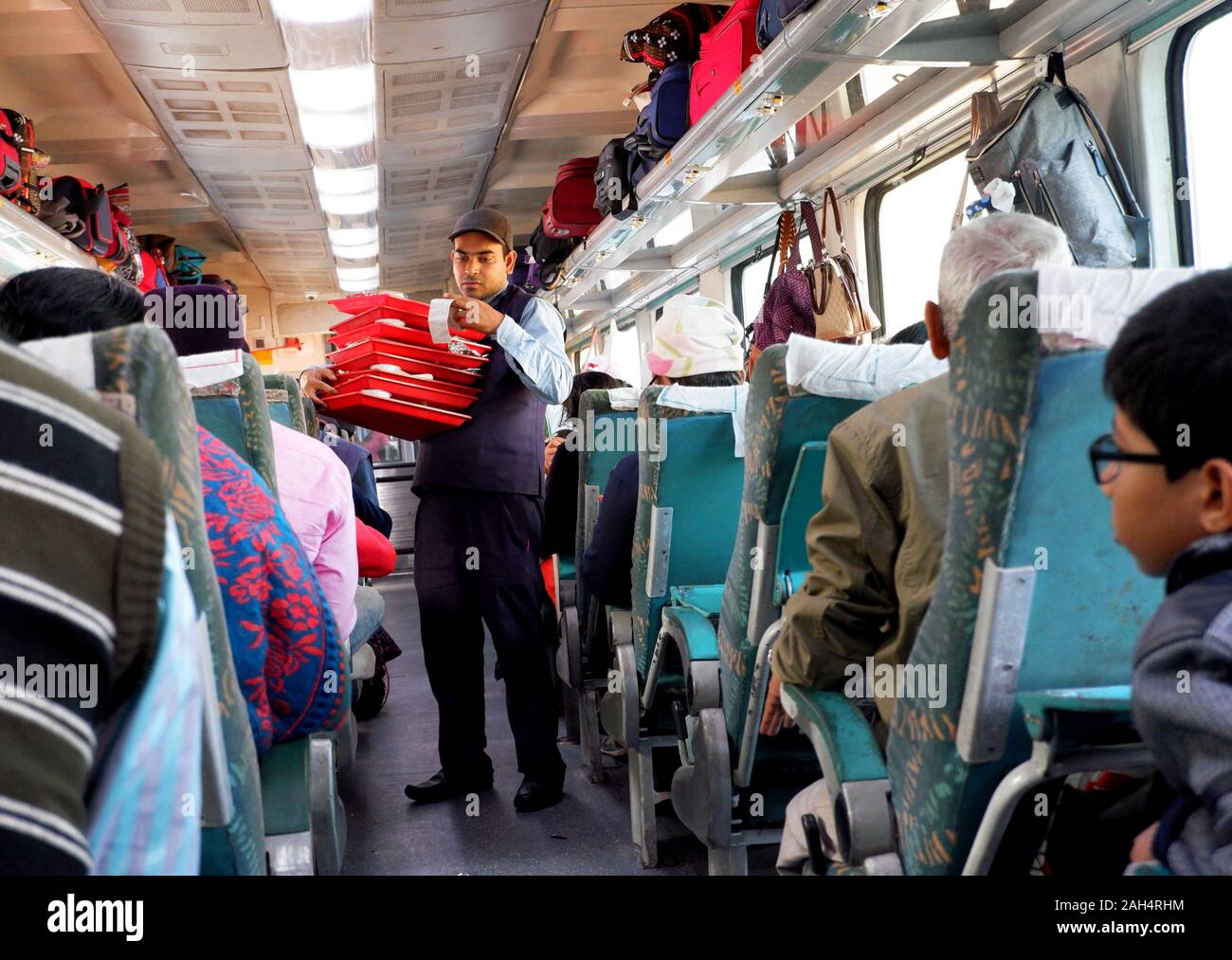 An executive of the IRCTC serves food in a Express Train Stock Photo ...