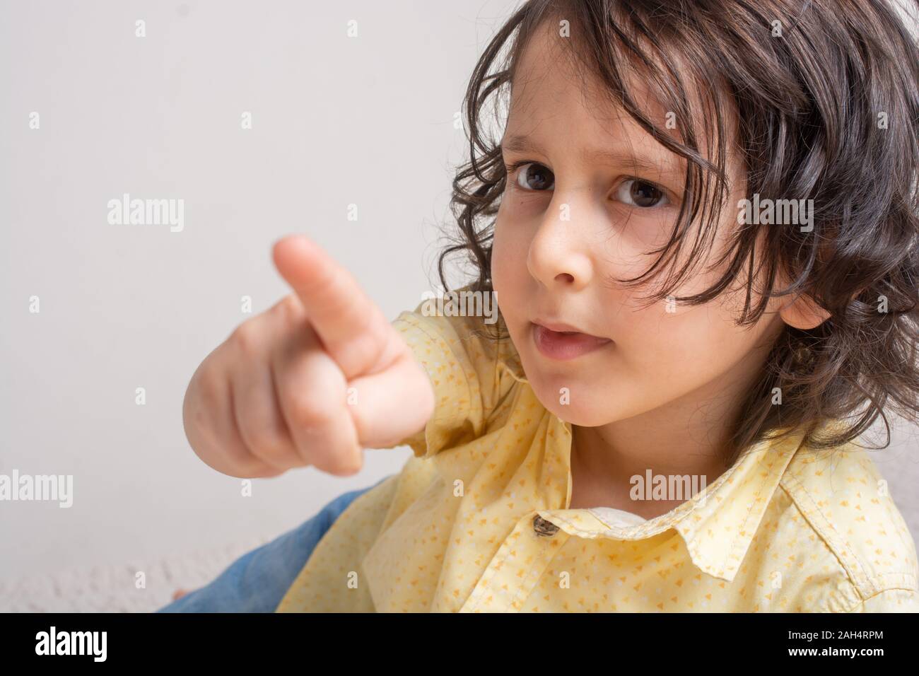 Sad kid boy pointing his finger away Stock Photo - Alamy
