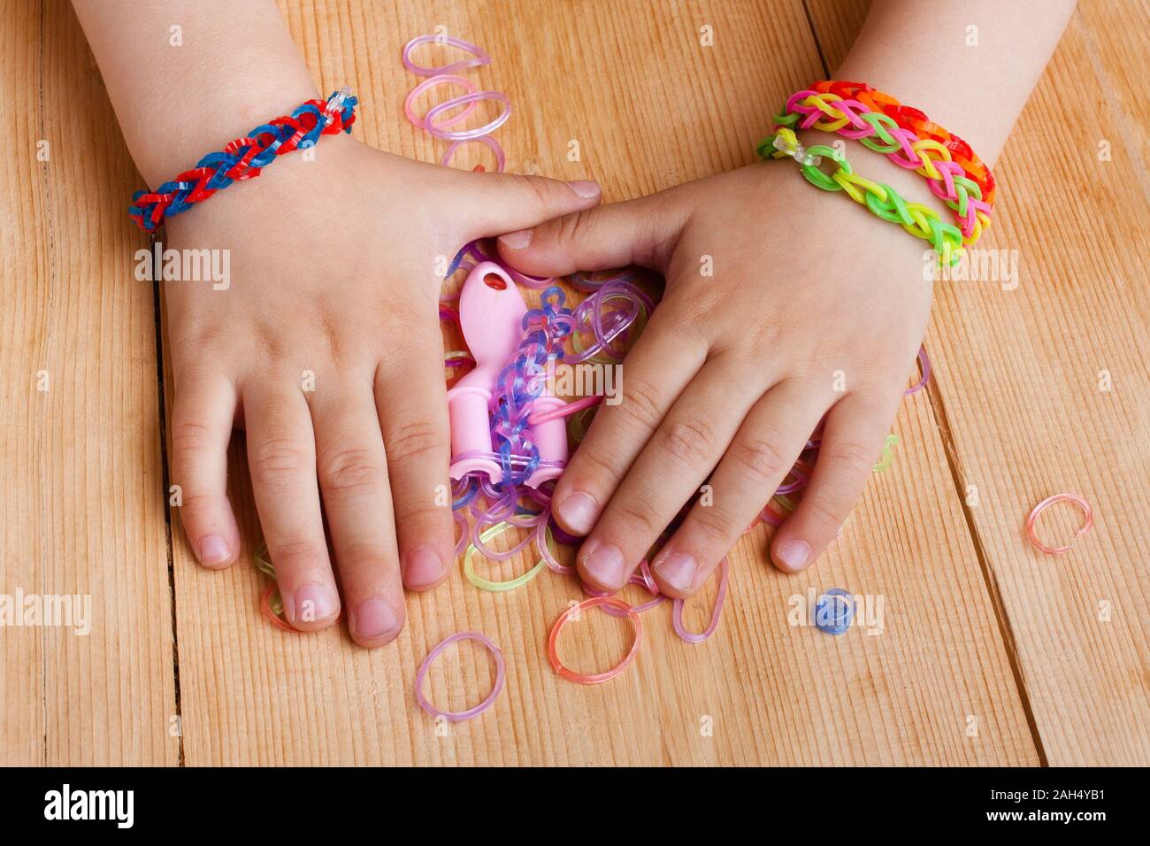 child hands with rubber bands on the wooden table Stock Photo - Alamy