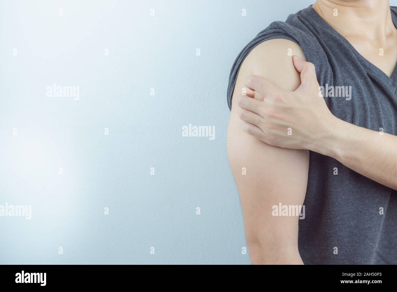 Closeup man holds his arm pain on white background. Health care and ...