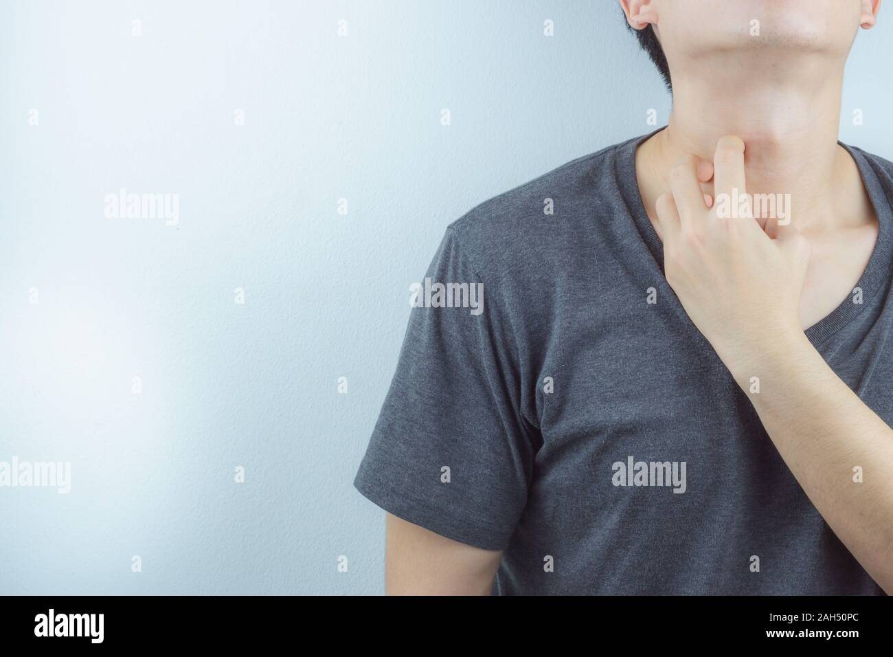 Close up man scratching his itchy neck with allergy rash by hand on ...
