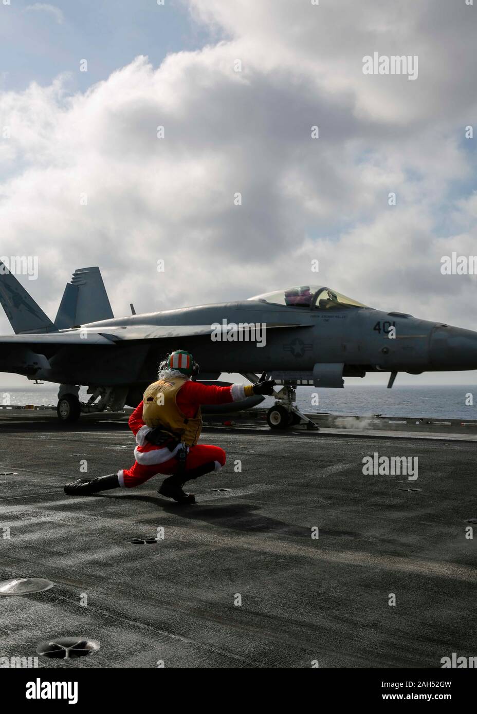 191224-N-GD018-2137 SOUTH CHINA SEA (Dec. 24, 2019) A Sailor dressed as ...