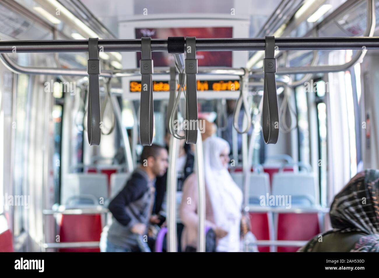 Close-up of holding places in the bus. Female passenger with closed ...
