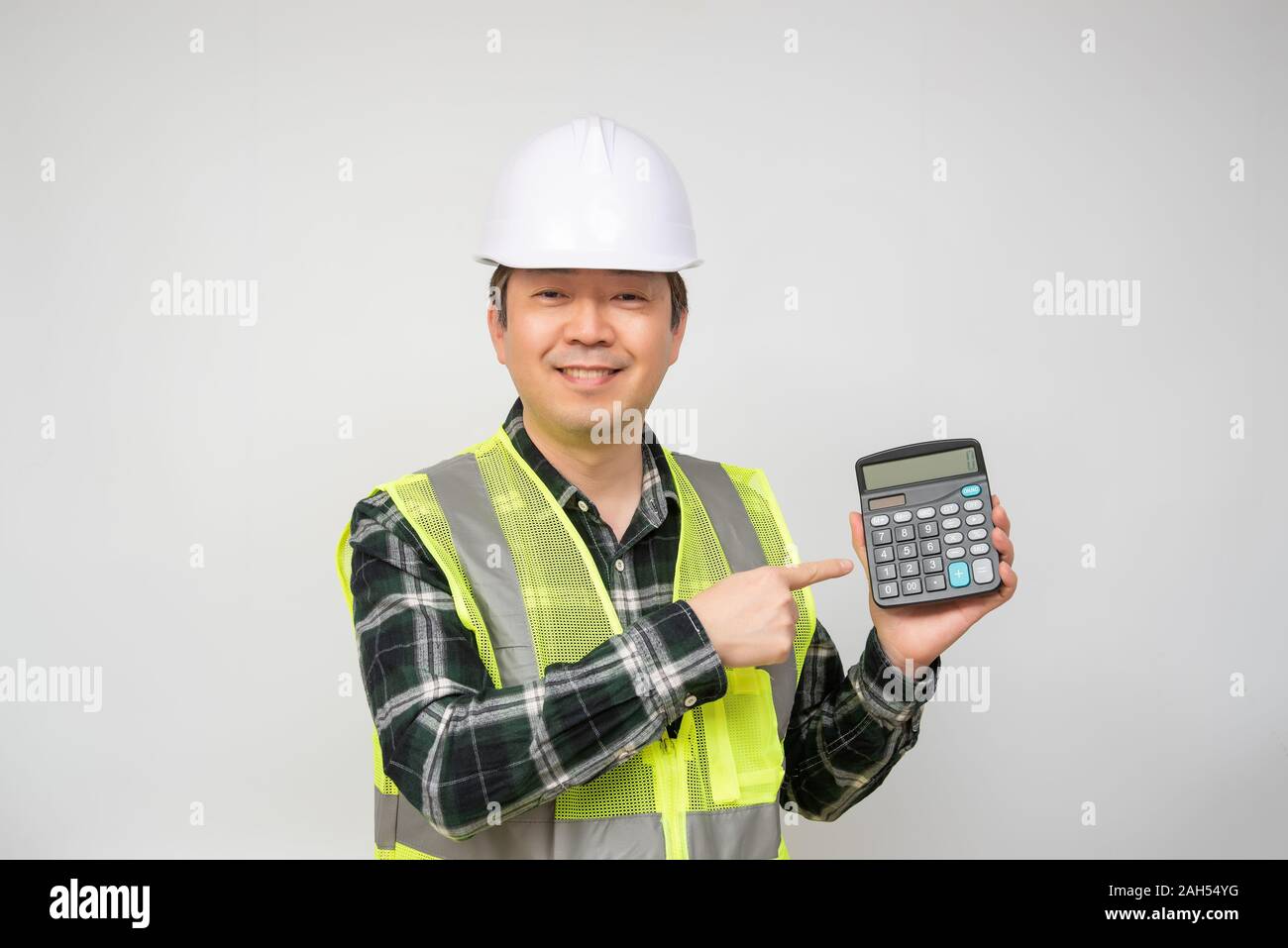 A middle-aged Asian man wearing a white work cap and work suit holding ...