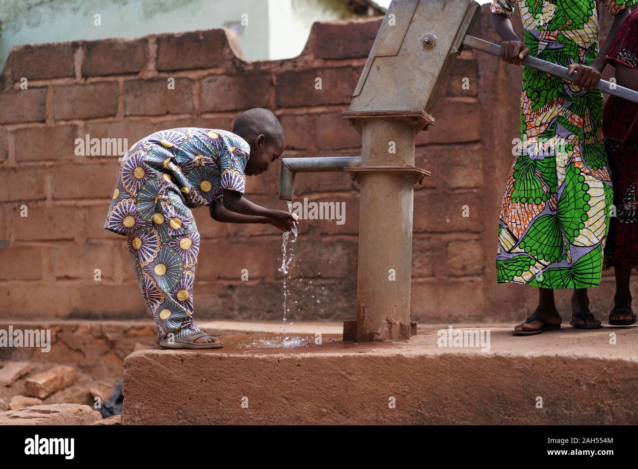 Boy drinking from tap africa hi-res stock photography and images - Alamy
