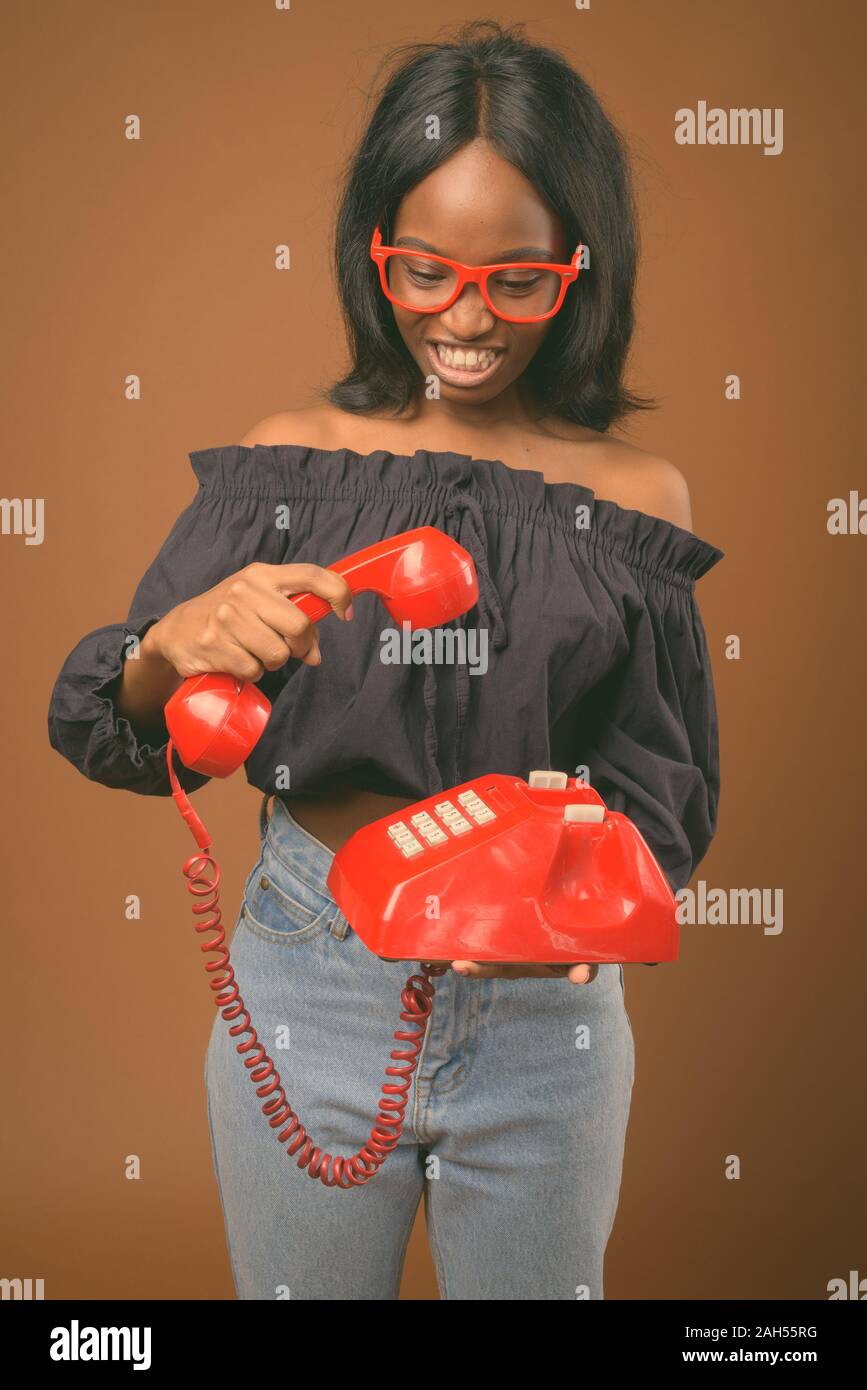 Studio shot of young beautiful African Zulu woman wearing off-shoulder ...