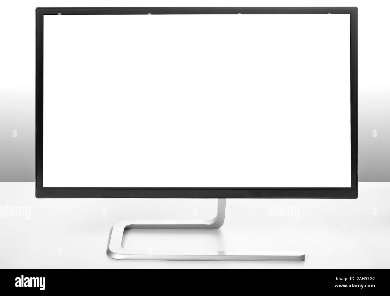 Modern monitor on white table and light background Stock Photo - Alamy