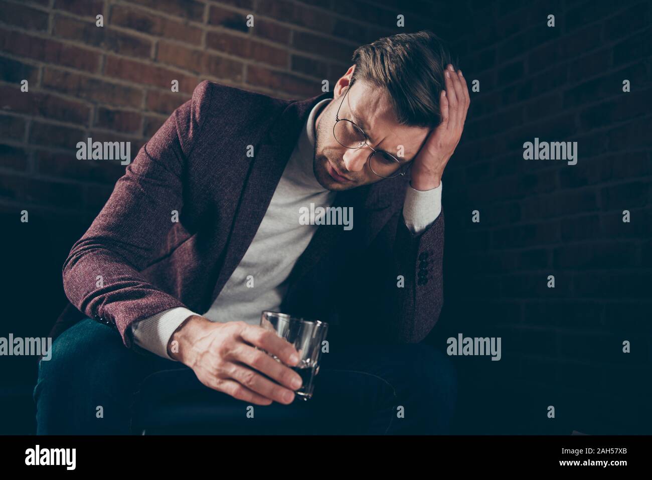 Photo of luxury macho business guy holding alcohol leaning head on hand ...