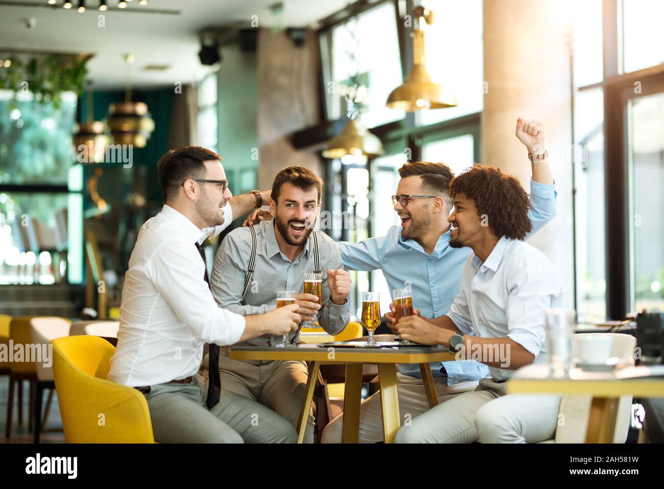 Celebrating good business cooperation at the bar Stock Photo - Alamy