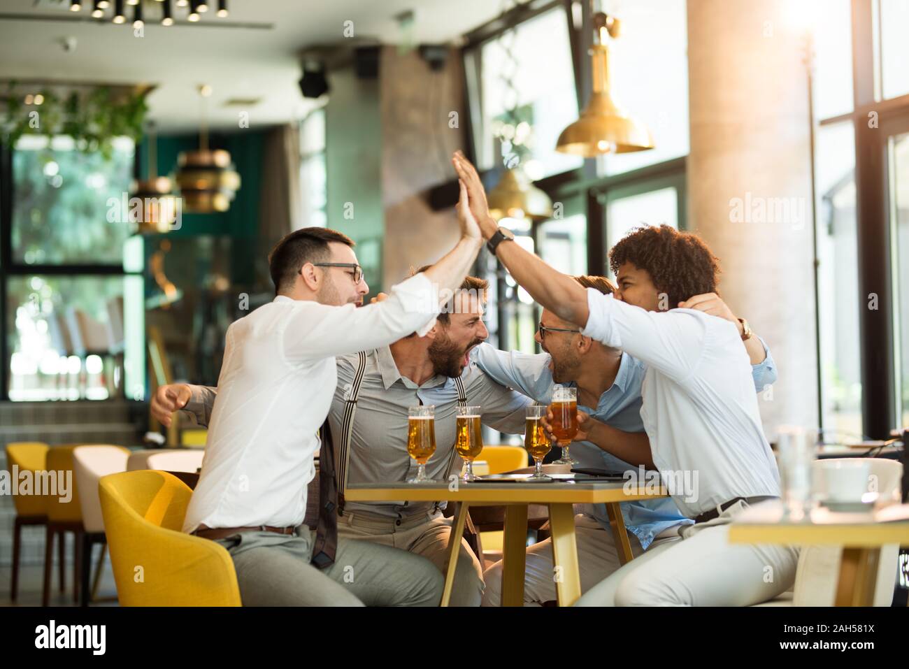 Celebrating good business cooperation at the bar Stock Photo - Alamy
