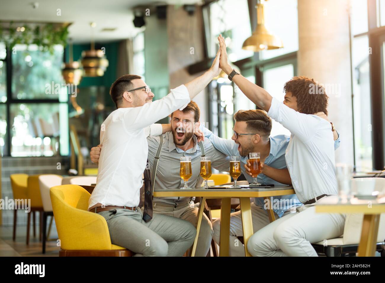 Celebrating good business cooperation at the bar Stock Photo - Alamy
