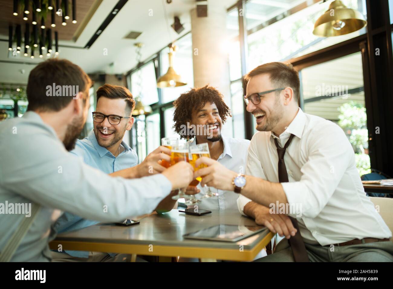 Celebrating good business cooperation at the bar Stock Photo - Alamy