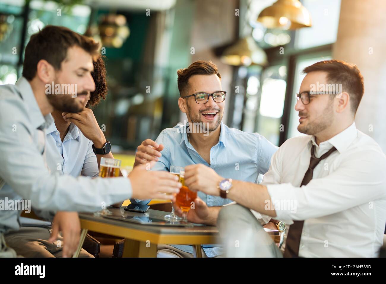 Celebrating good business cooperation at the bar Stock Photo - Alamy