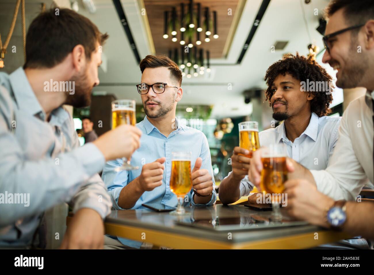 Celebrating good business cooperation at the bar Stock Photo - Alamy