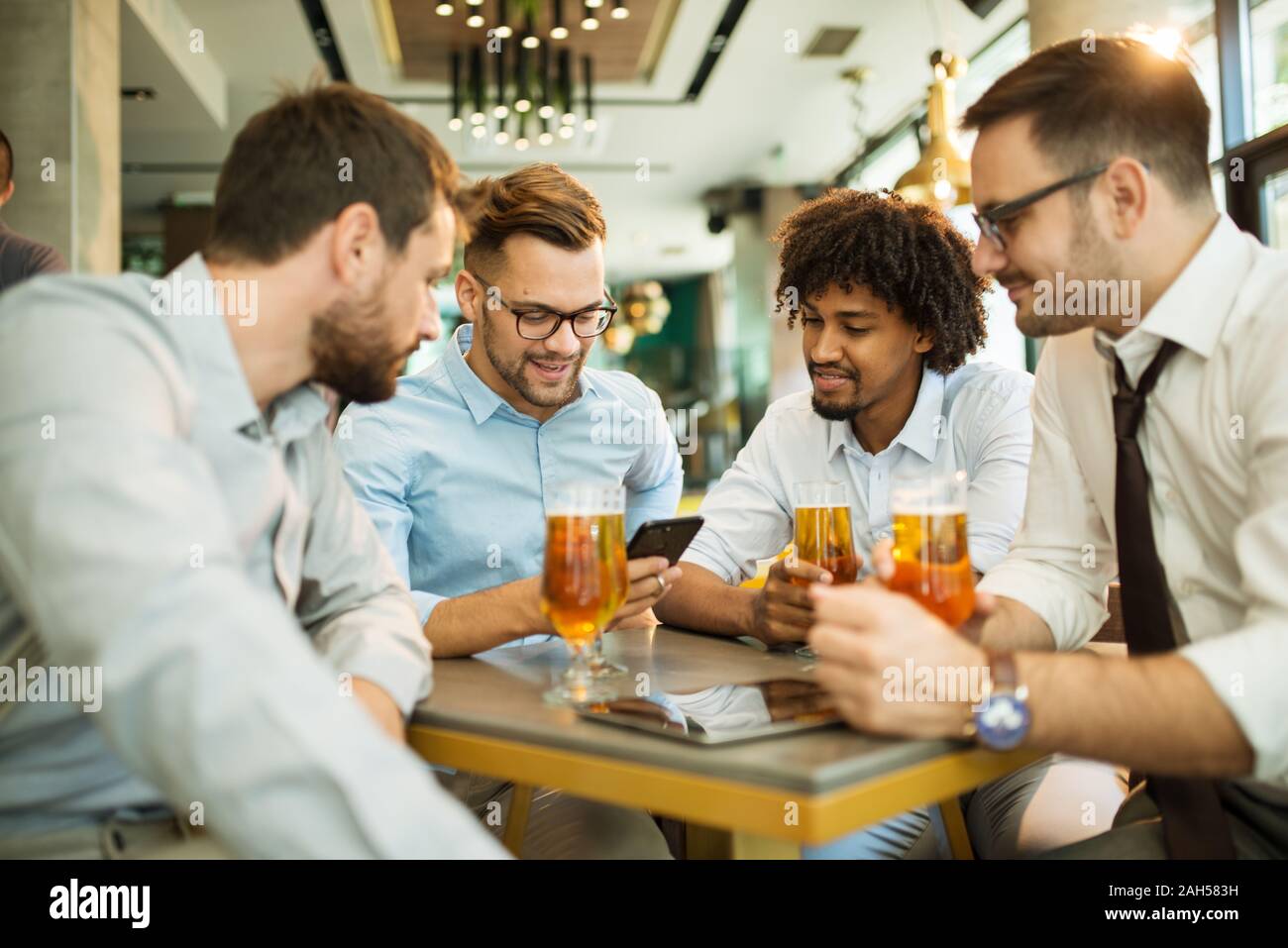 Celebrating good business cooperation at the bar Stock Photo - Alamy