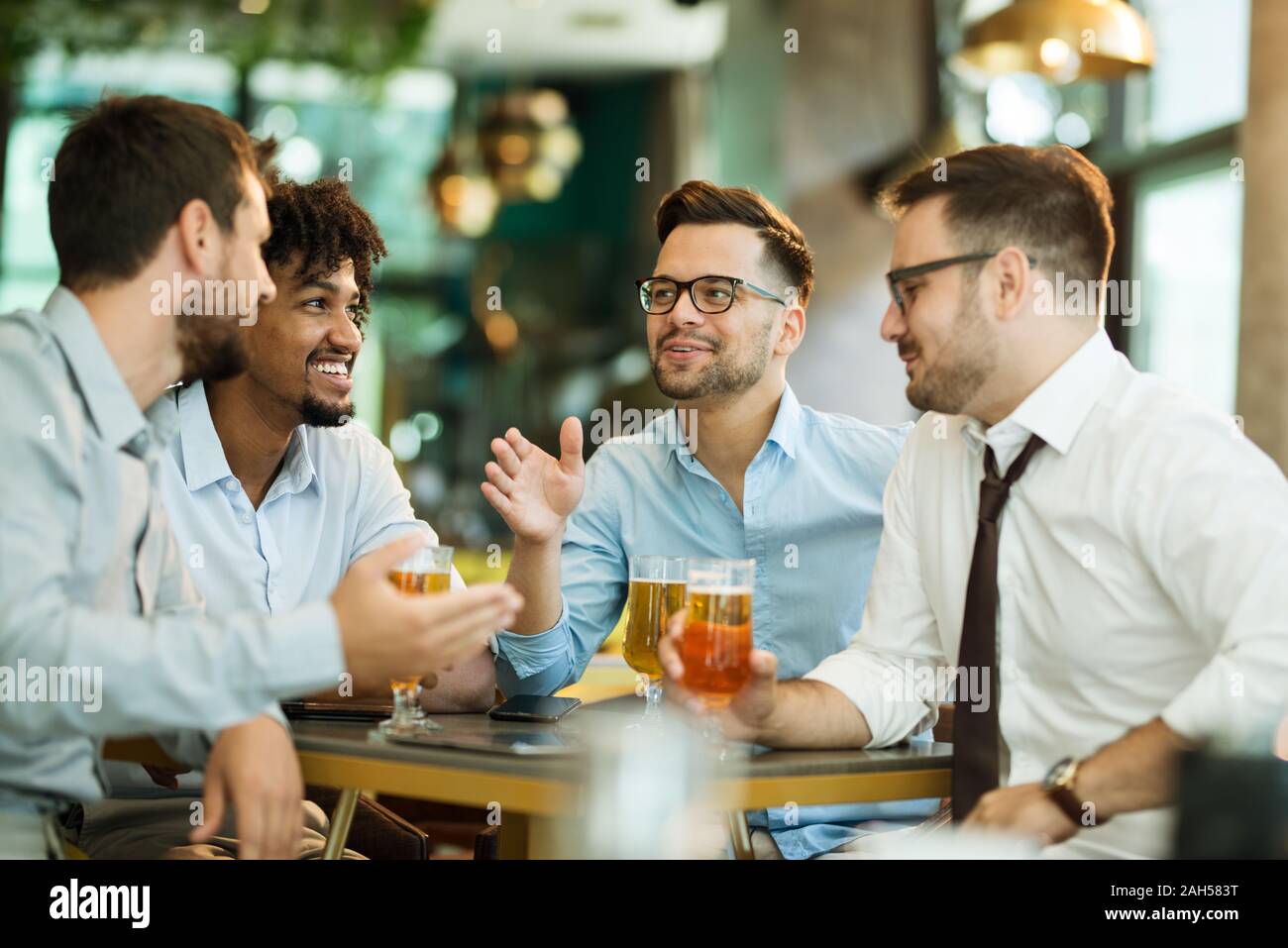 Celebrating good business cooperation at the bar Stock Photo - Alamy