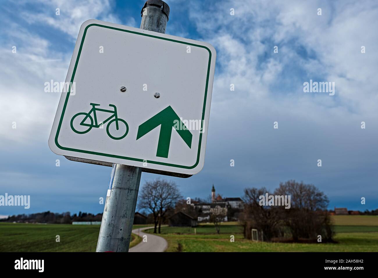 road sign with a bike and an arrow showing the direction to the ...