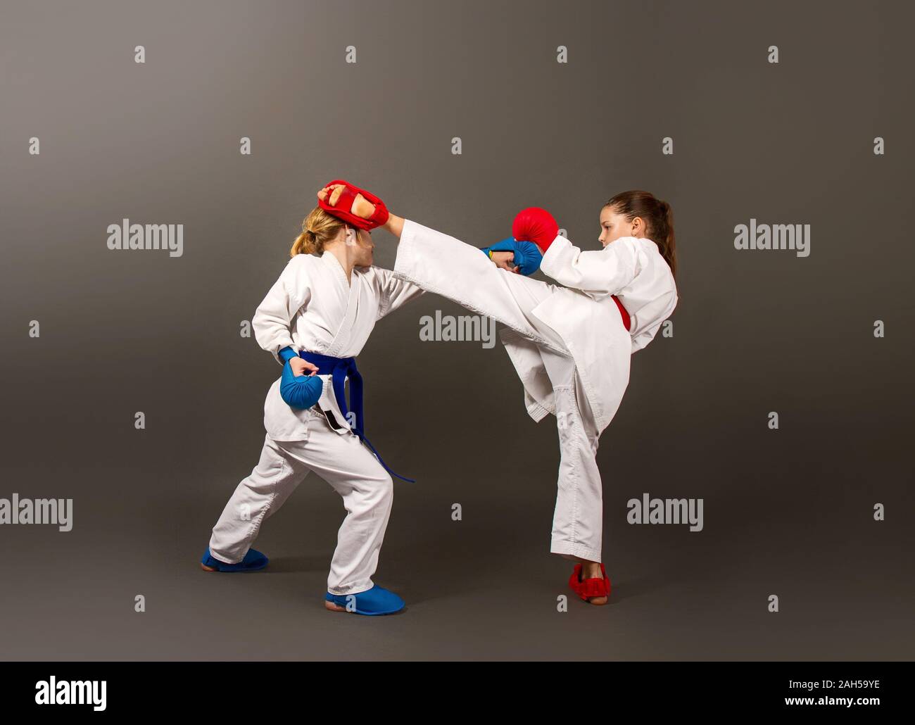 Sport Karate fight two little girls in white kimono in red one second ...